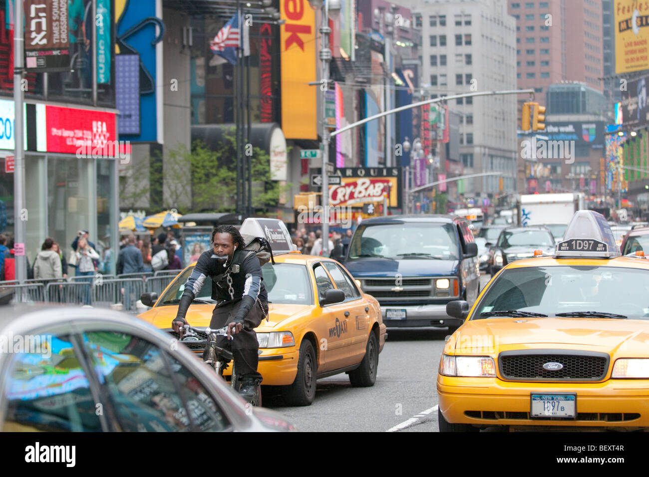 A cycle courier riding in heavy traffic in Times Square, Manhattan, New ...