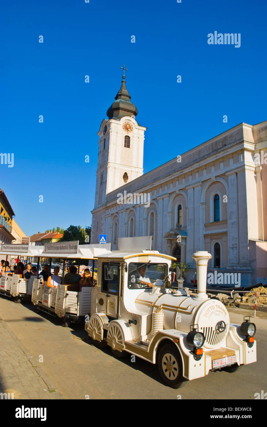 Tourist train in front of Franciscan church Pecs Hungary Europe Stock ...