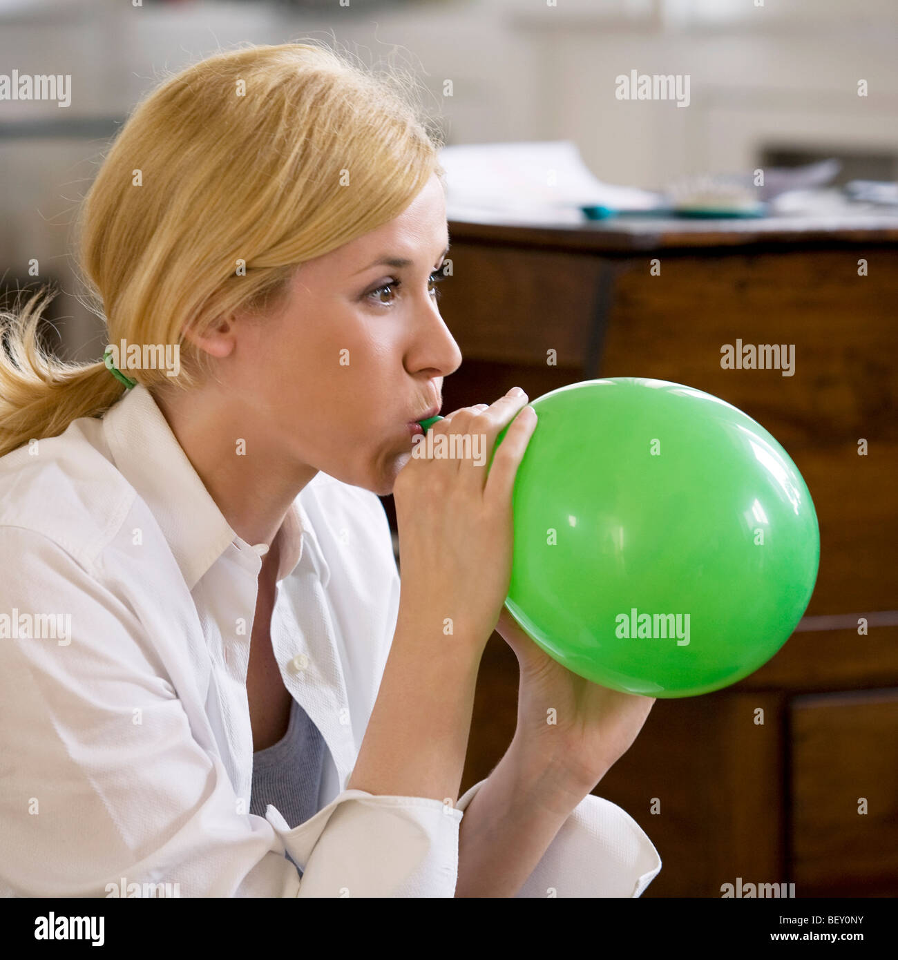 woman inflating balloon Stock Photo - Alamy
