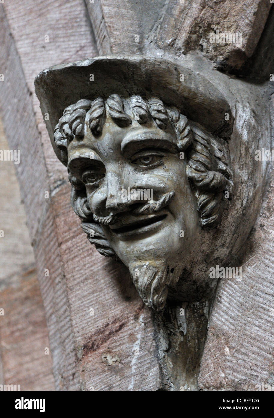 Sculpted head of a man with goatee beard , moustache and hat . Church ...