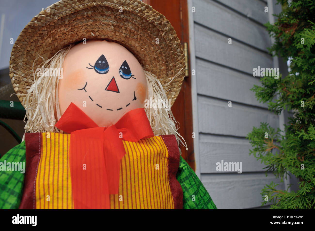 A stuffed doll done up like a country man with straw hat for fall ...