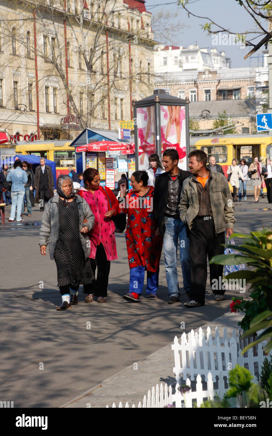 A group of gypsies is walking on a street of Kyiv, Ukraine on summer ...
