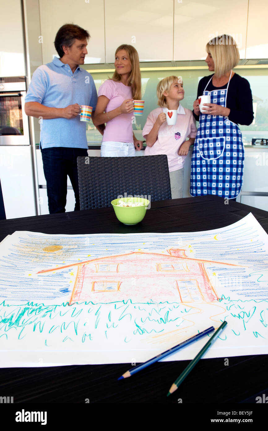 family in the kitchen, pencils and drawing on the table Stock Photo - Alamy