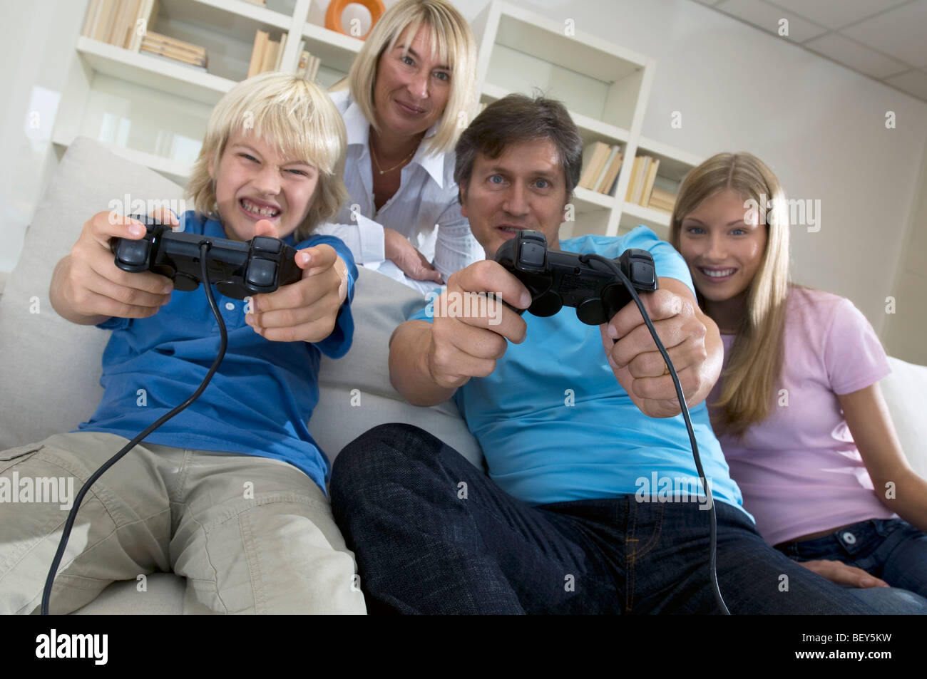 family in livingroom, father and son playing with playstation Stock ...