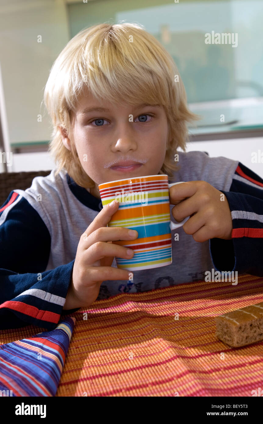 boy in kitchen eating breakfast Stock Photo - Alamy