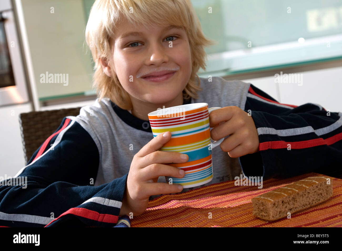 boy in kitchen eating breakfast Stock Photo - Alamy