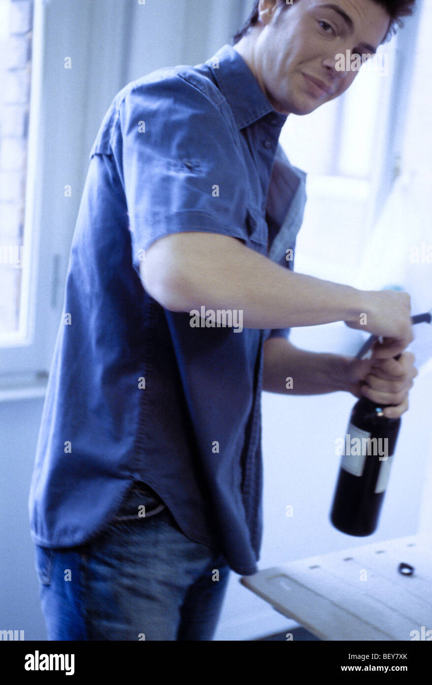 man uncorking a bottle Stock Photo - Alamy