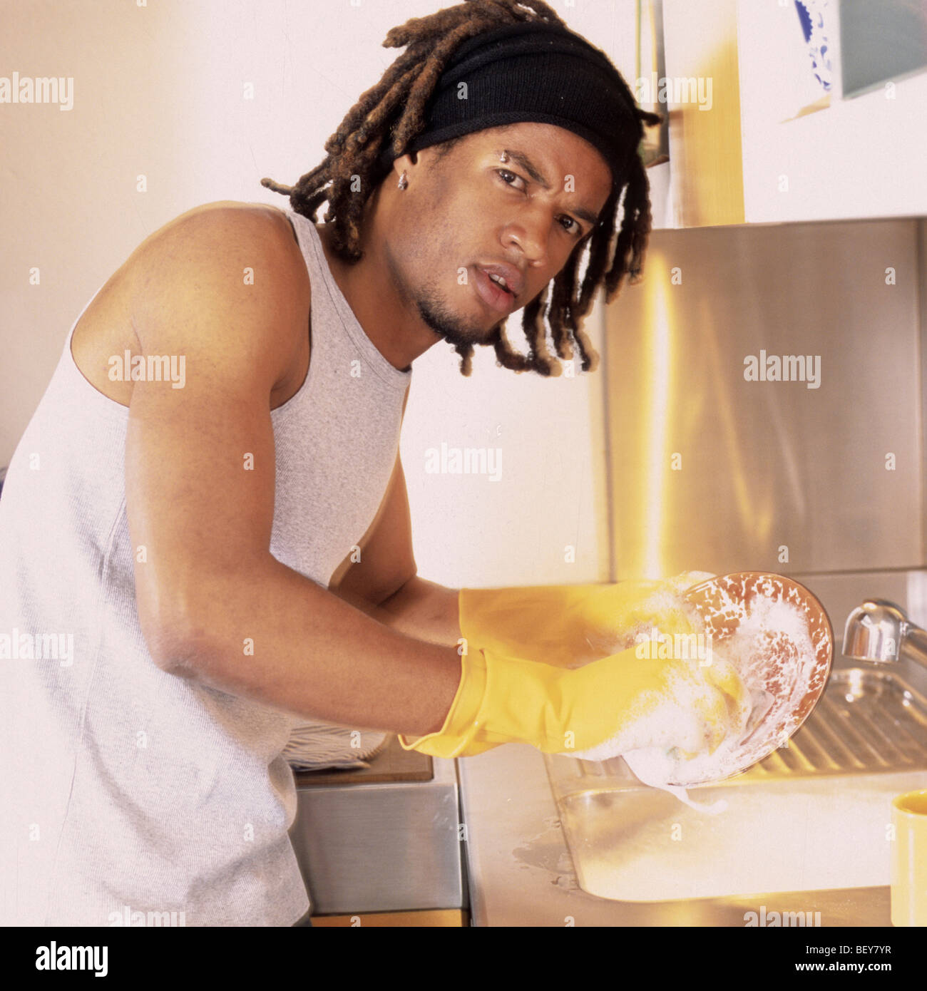 young man clening plates Stock Photo - Alamy