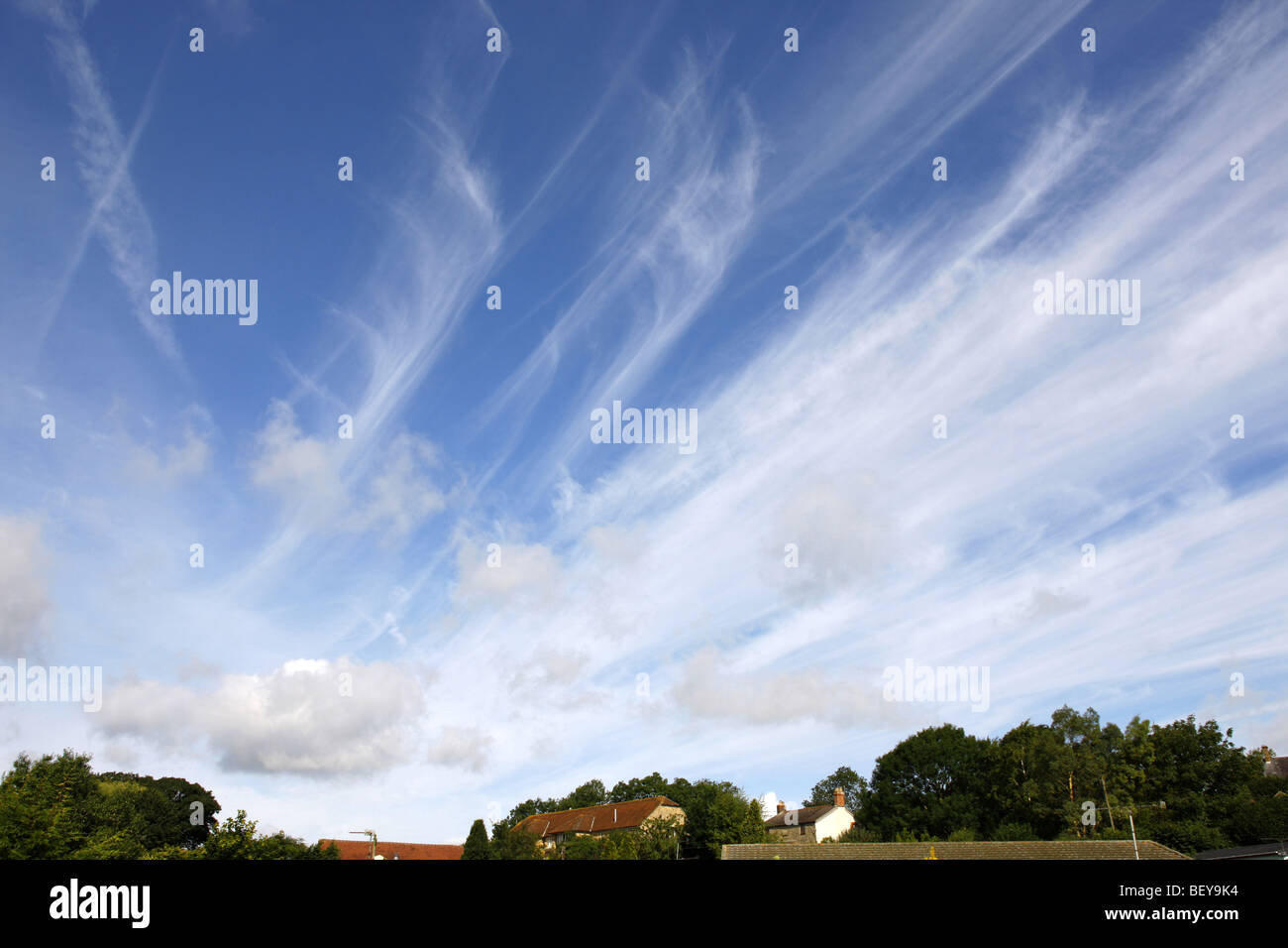 Wisps of white clouds showing strong winds at high altitude Stock Photo ...