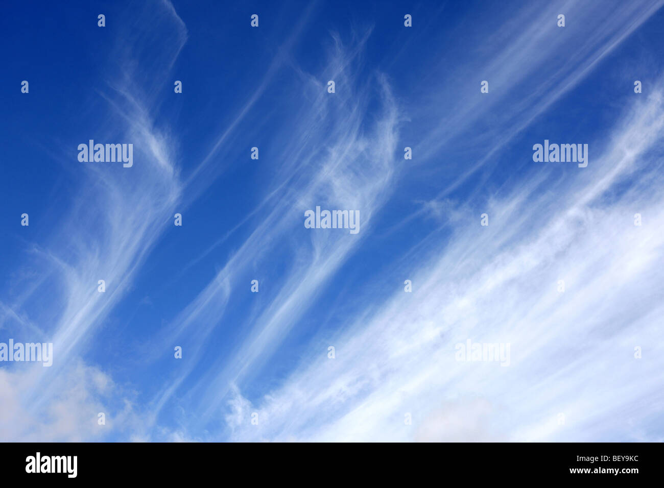 Wisps of white clouds showing strong winds at high altitude Stock Photo ...