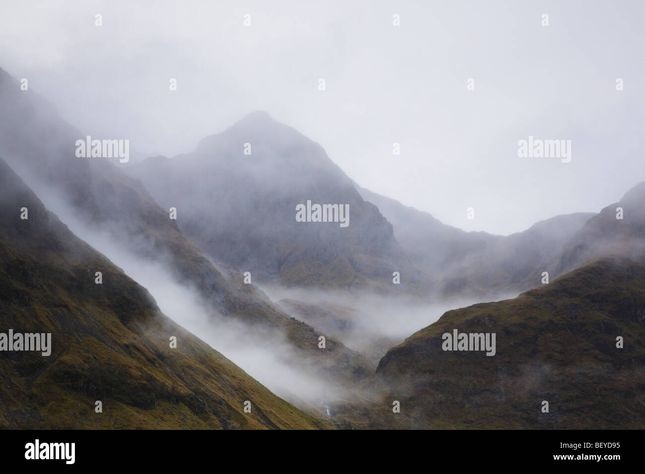 Low rain clouds hug the mountains in Glen Coe, Scotland Stock Photo - Alamy