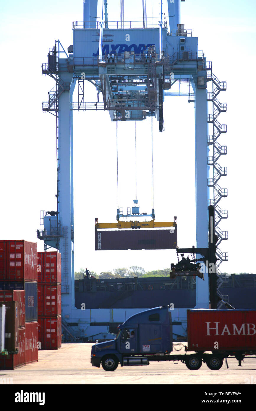 Loading containership in port Stock Photo - Alamy