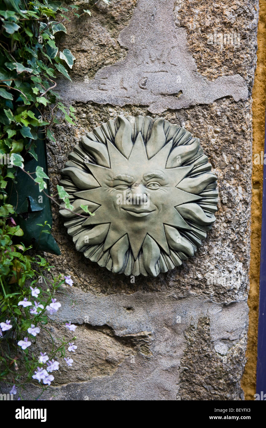 a winking man in the sun wall plaque Stock Photo - Alamy