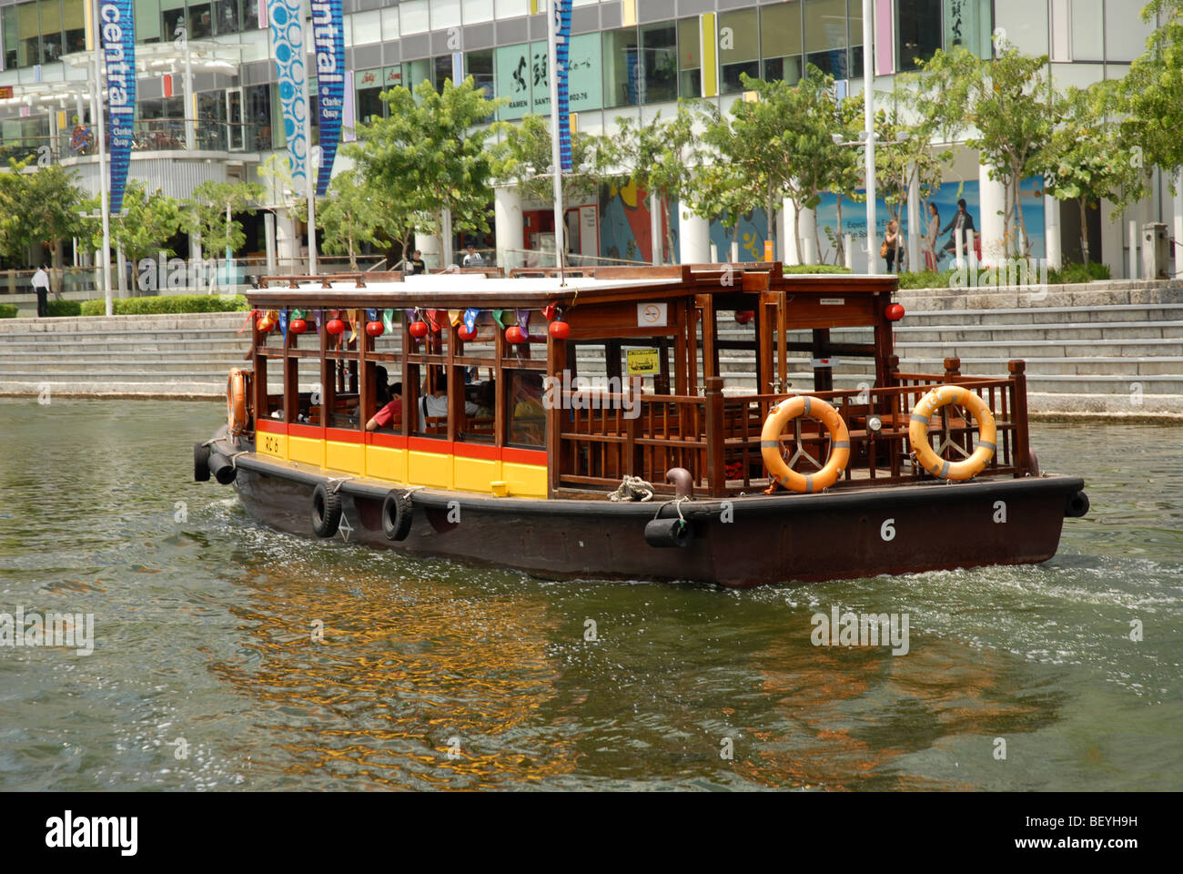 passenger boat on the Singapore River passing the Central building ...