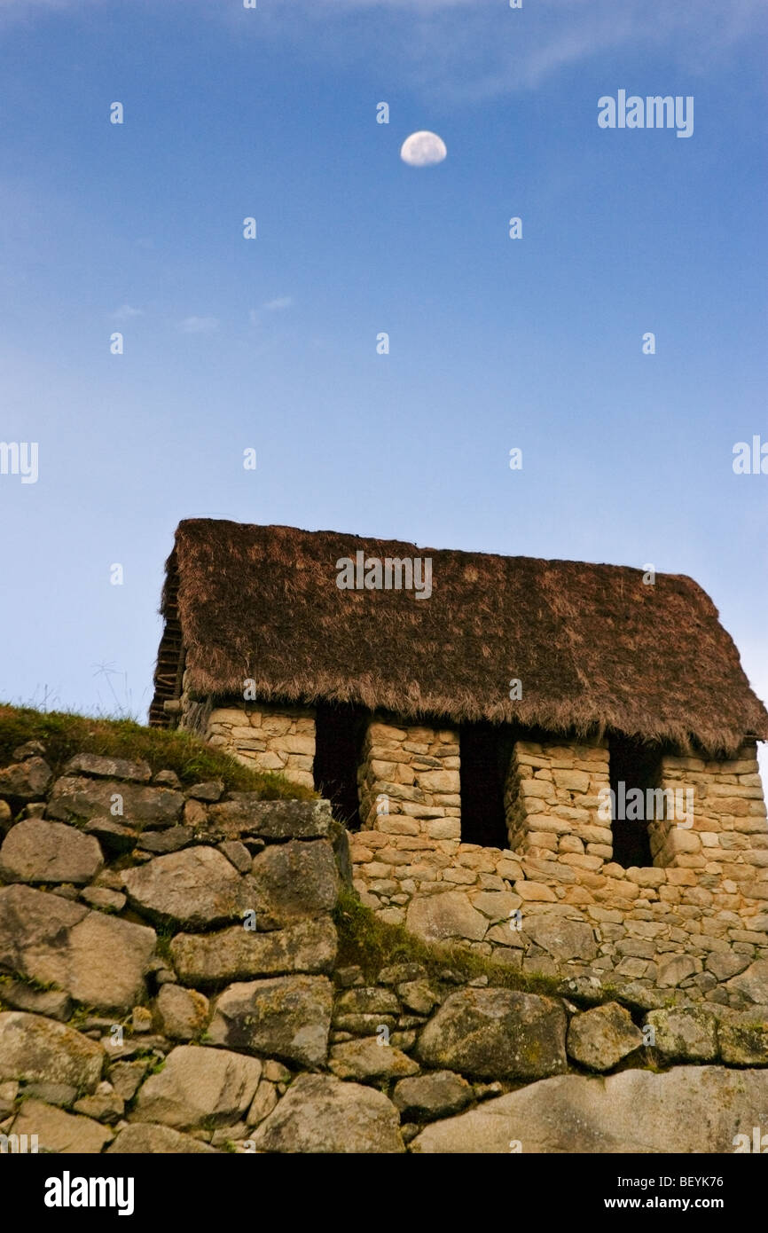Moon rising over ancient grain storage building reconstructed at the ...