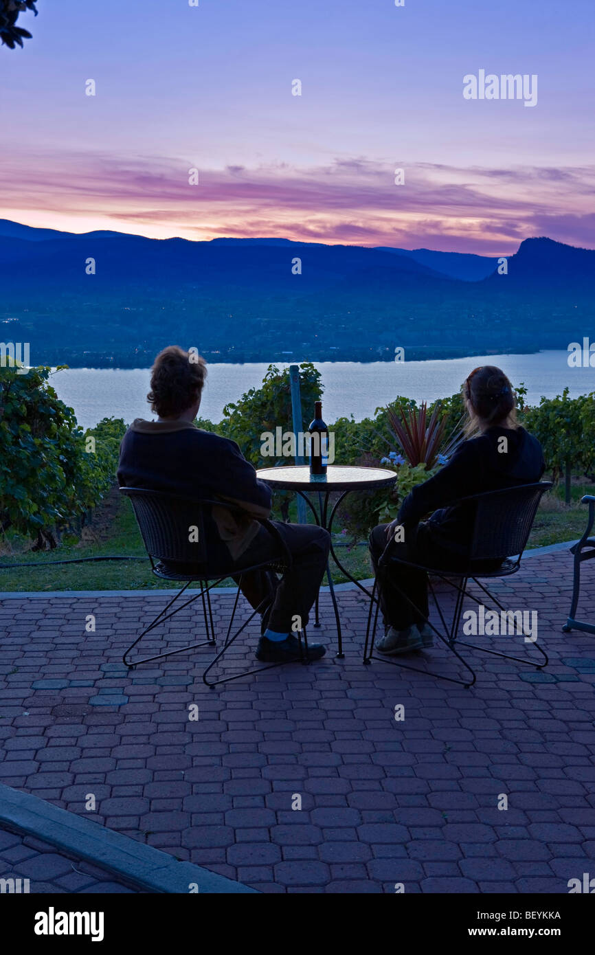 Couple sitting at a patio table overlooking the grapevines of Lang ...