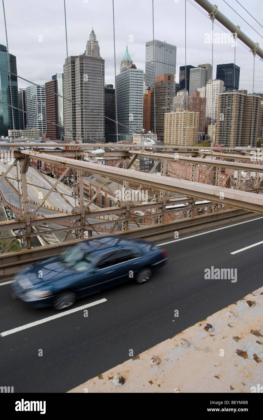 A car speeding over the Brooklyn Bridge, with the New York City skyline ...