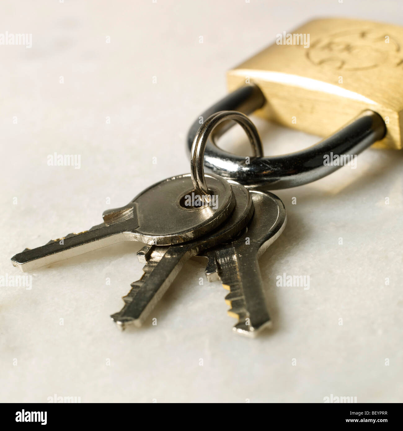 Padlock with three keys Stock Photo - Alamy