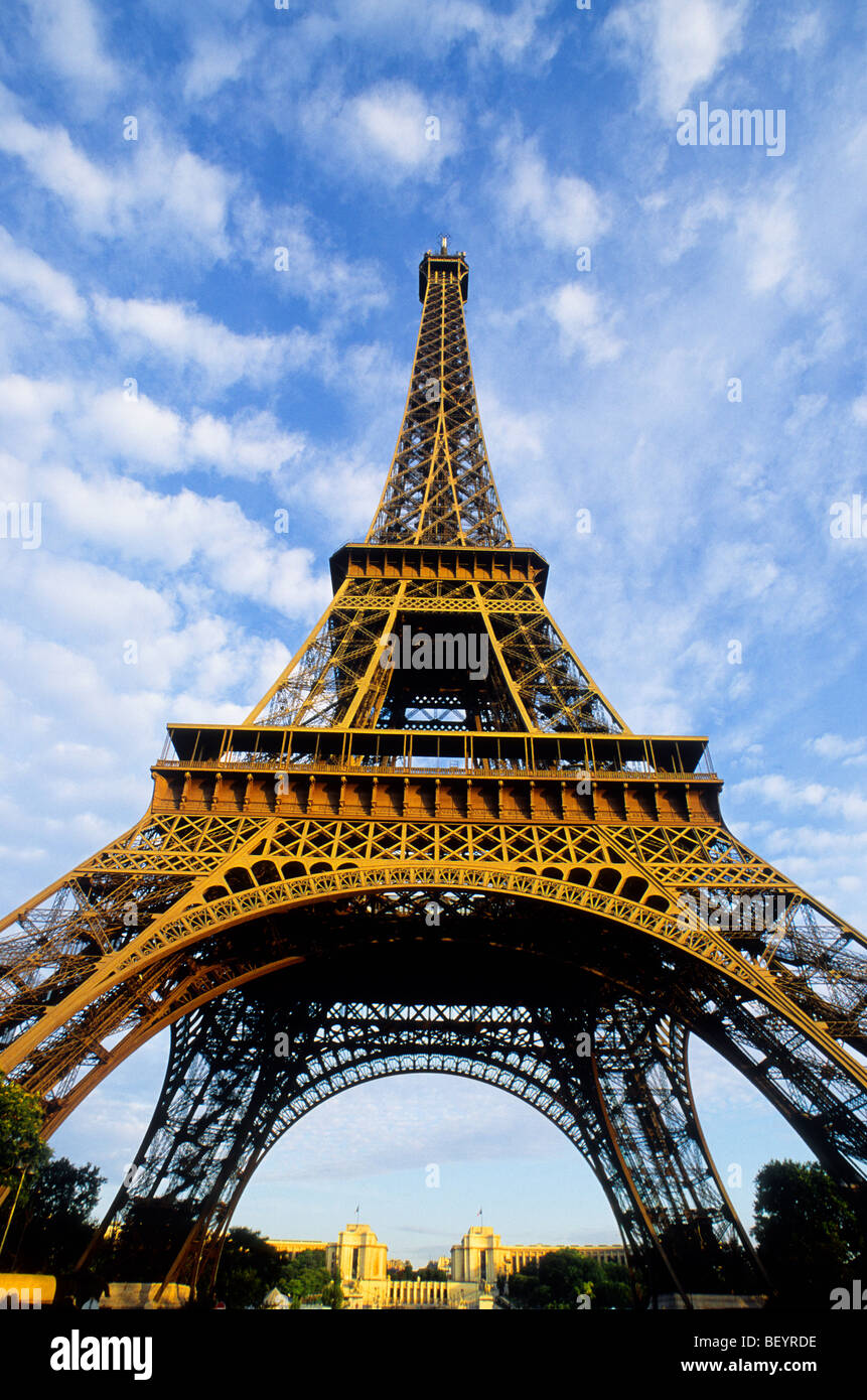 Eiffel Tower structure, from below at dawn. Paris. Early morning clouds over Champ de Mars ...