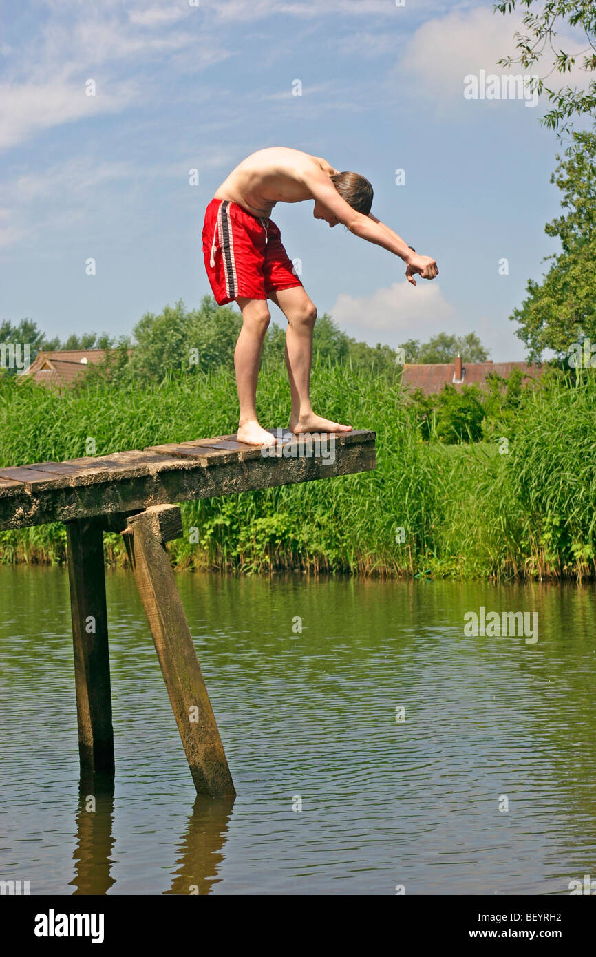 teenage boy going to jump into a river Stock Photo - Alamy