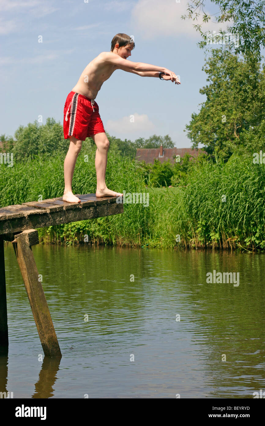 teenage boy going to jump into a river Stock Photo - Alamy