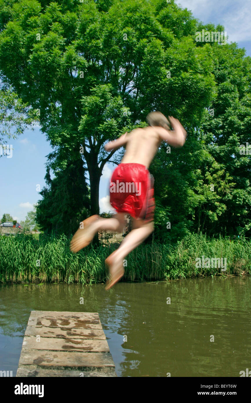 teenage boy jumping into a river Stock Photo - Alamy