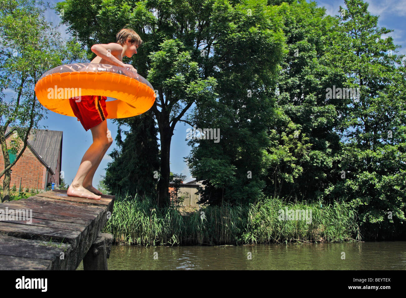 teenage boy going to jump into a river Stock Photo - Alamy
