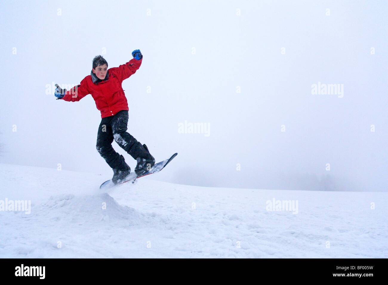 teenage boy practicing to jump with his snowboard Stock Photo - Alamy