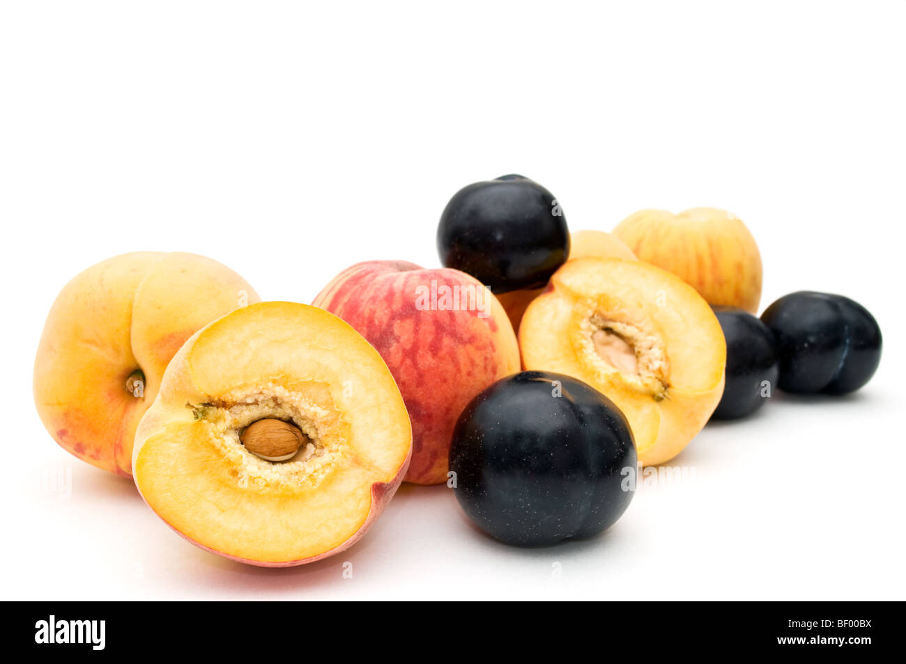 Peaches and plums on a white background Stock Photo - Alamy