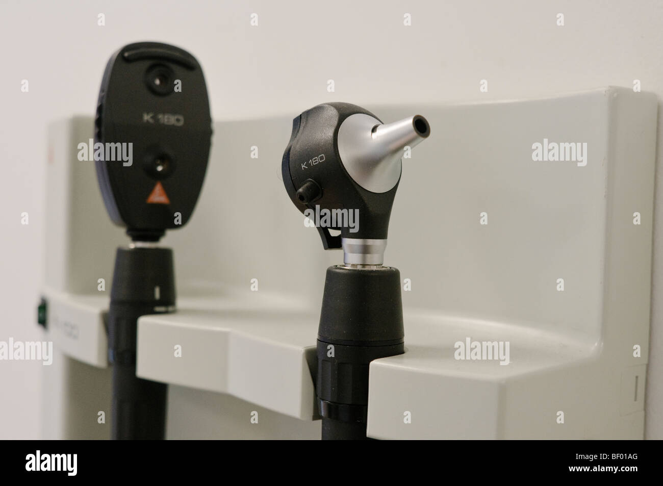 Opthalmoscope and oroscope mounted on a wall in a consulting room of a ...