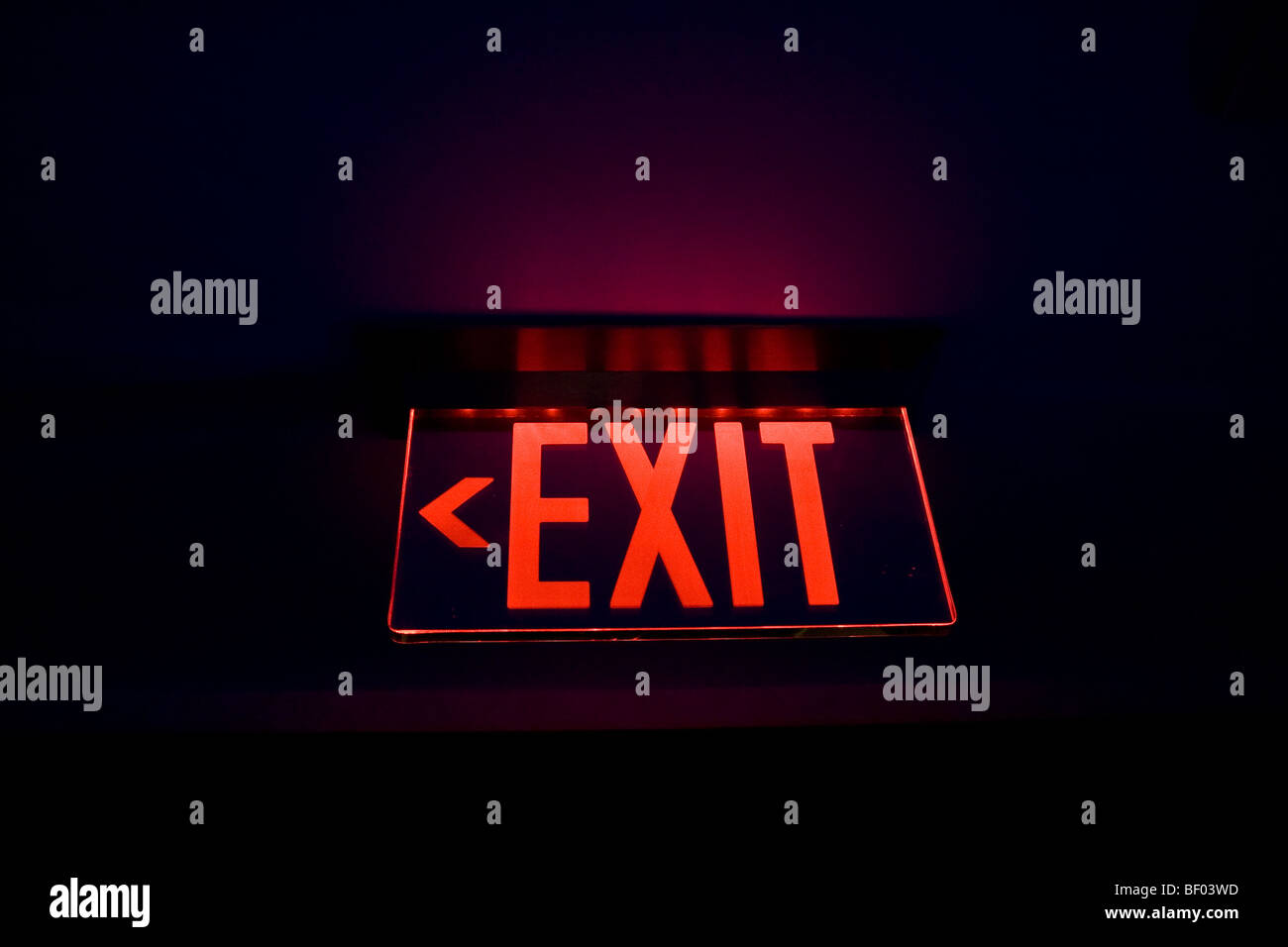 Red exit sign dark background Stock Photo - Alamy