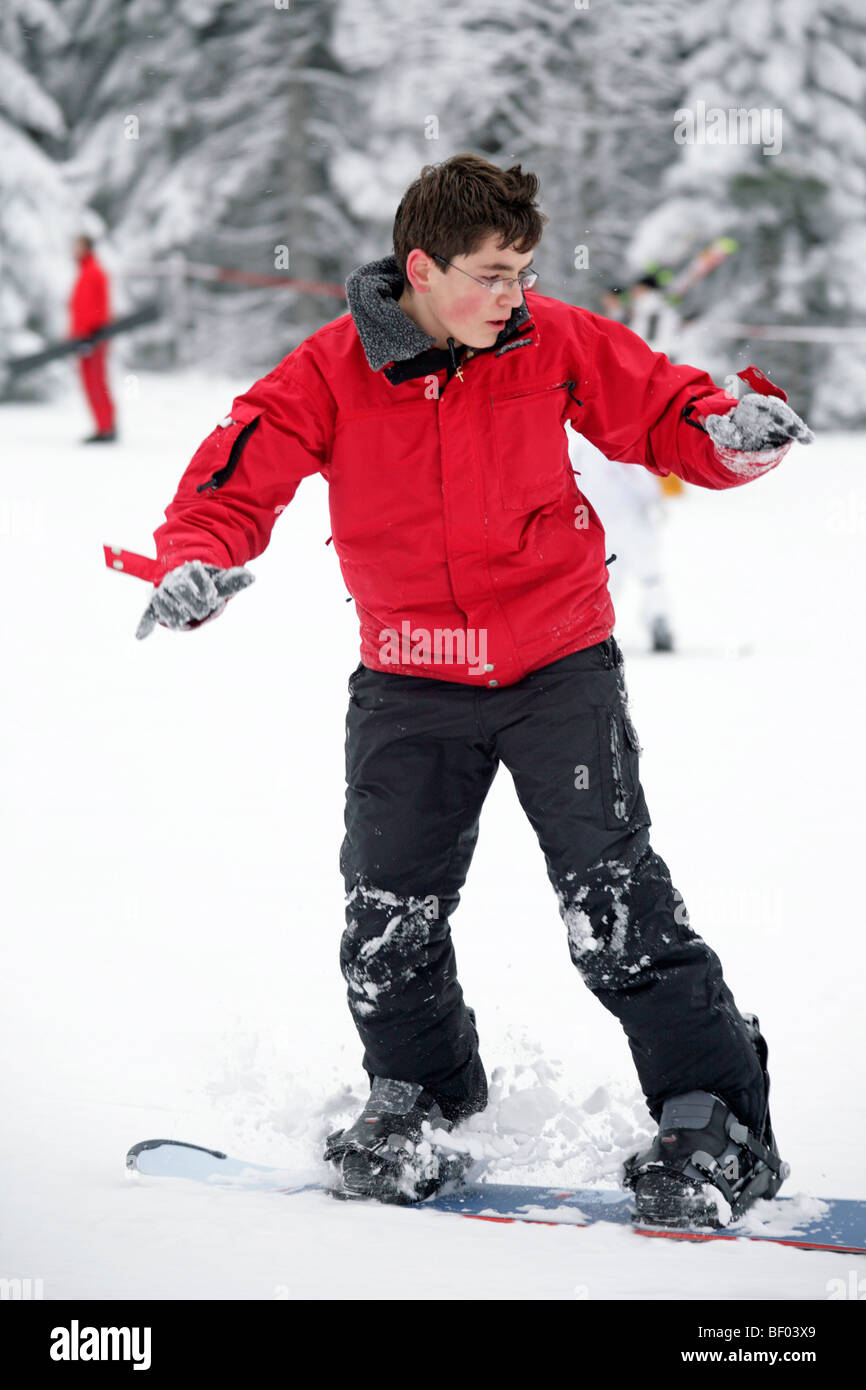 teenage boy practicing to snowboard Stock Photo - Alamy
