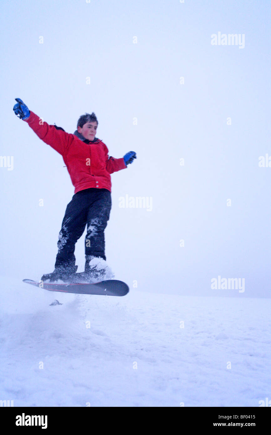 teenage boy practicing to jump with his snowboard Stock Photo - Alamy