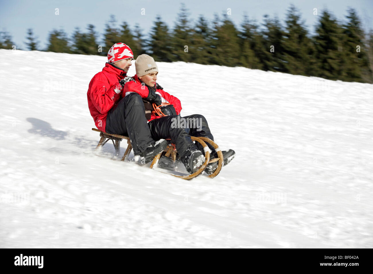 two young boys tobogganing together Stock Photo - Alamy