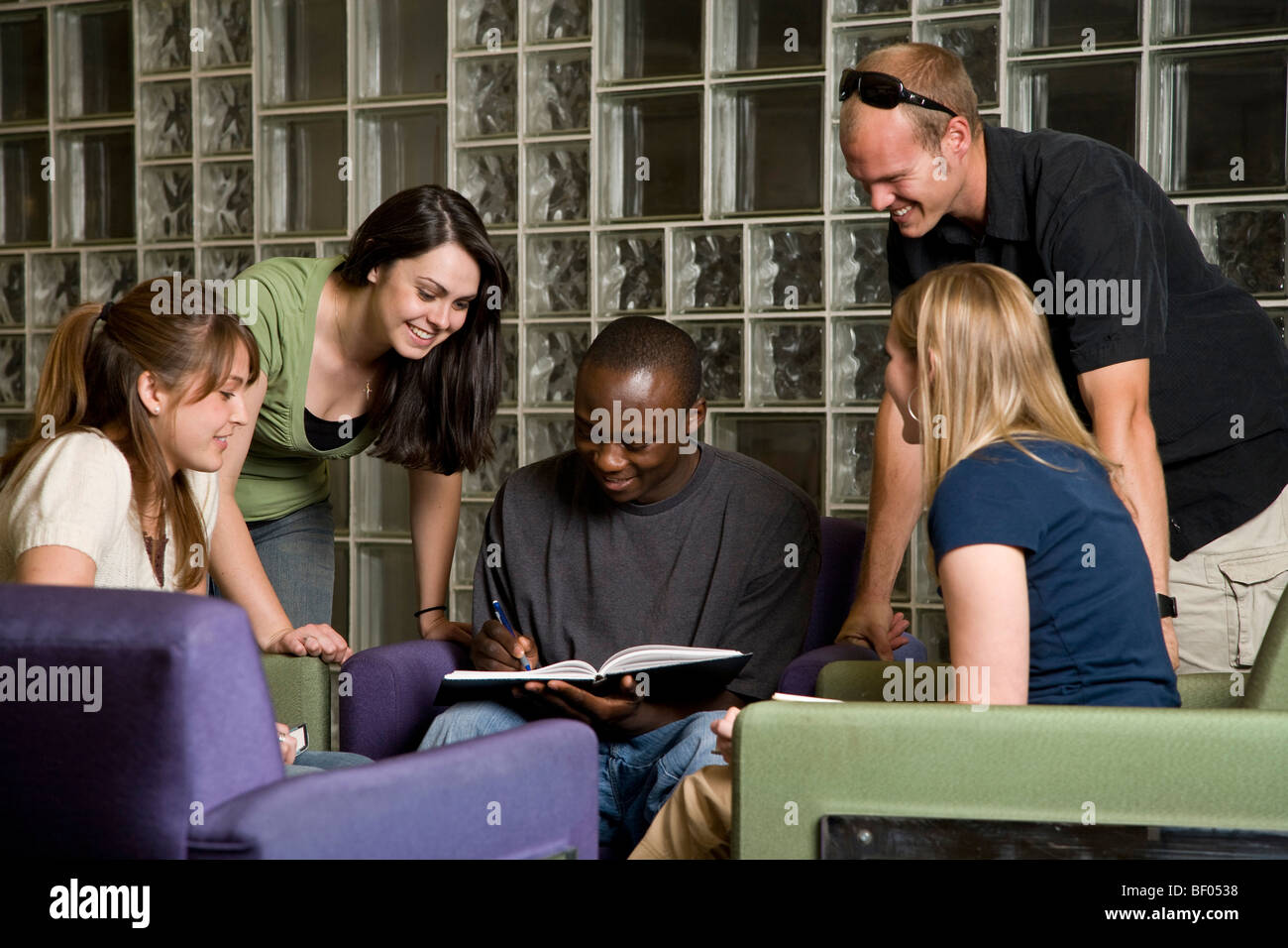 Group of young adults study together in a library Stock Photo - Alamy