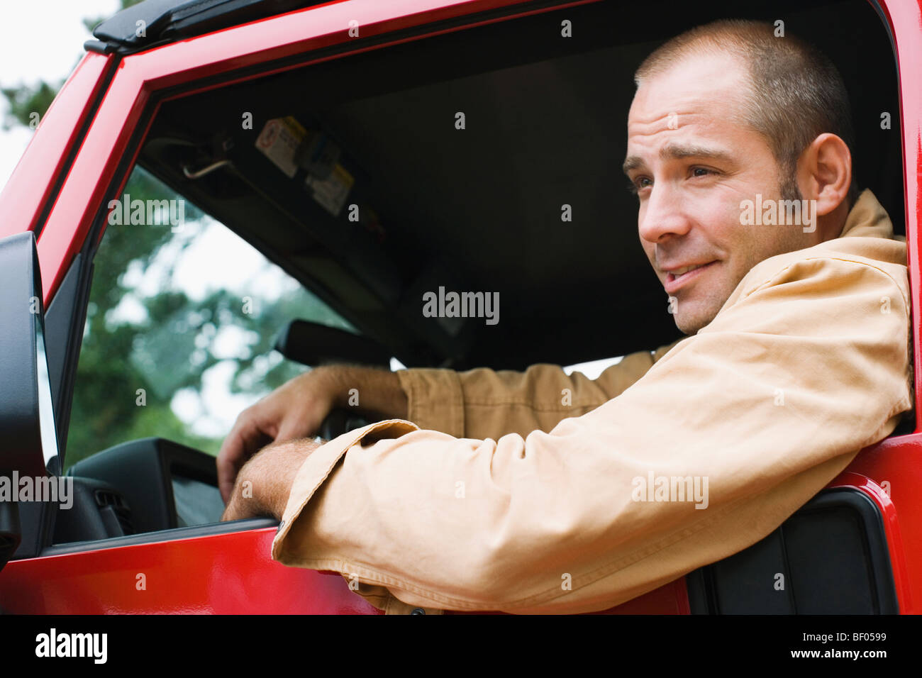 Man driving a jeep and smiling Stock Photo - Alamy