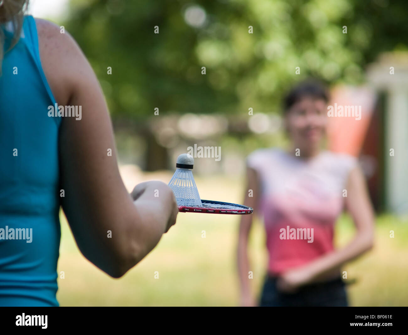 Two ladies ready to play badminton focus on shuttle Stock Photo - Alamy