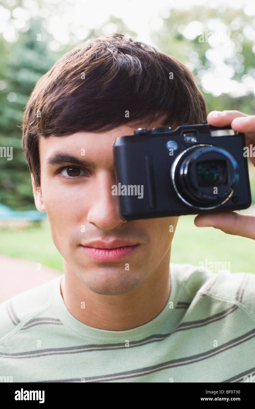 Portrait of man taking picture with camera Stock Photo - Alamy
