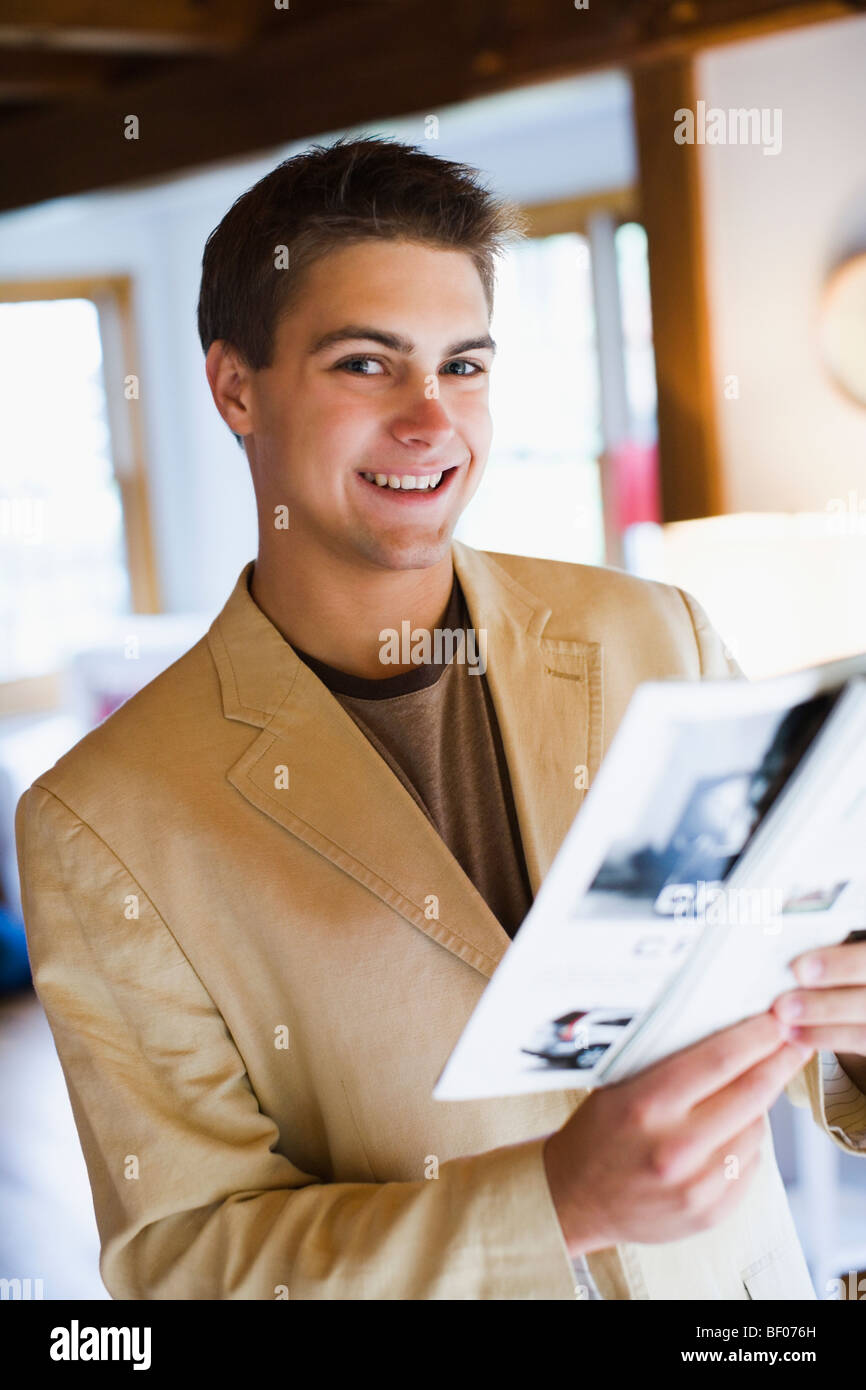 Man holding a magazine Stock Photo - Alamy