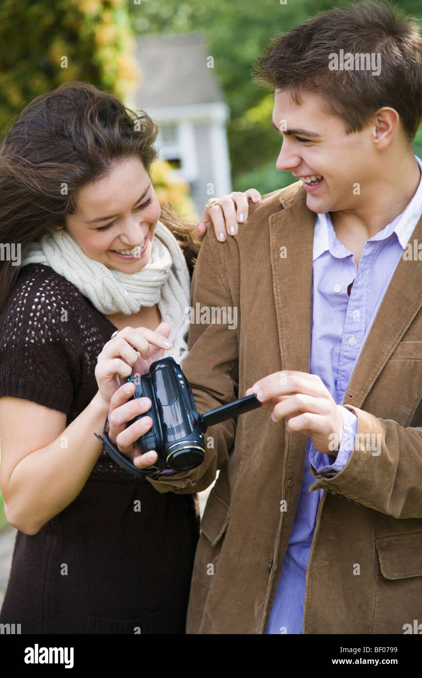 Woman standing beside man and looking at video camera Stock Photo - Alamy
