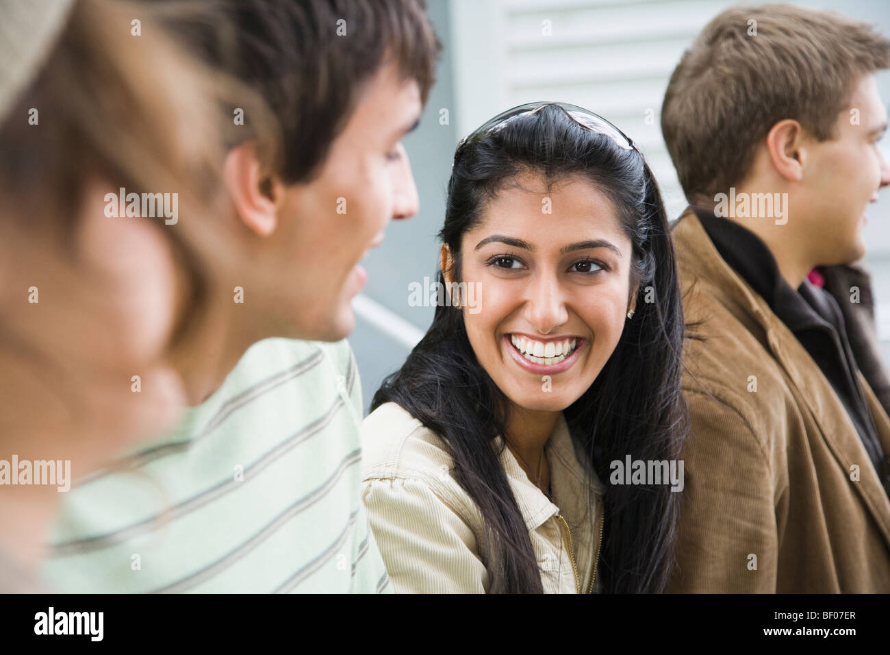 Four friends smiling Stock Photo - Alamy