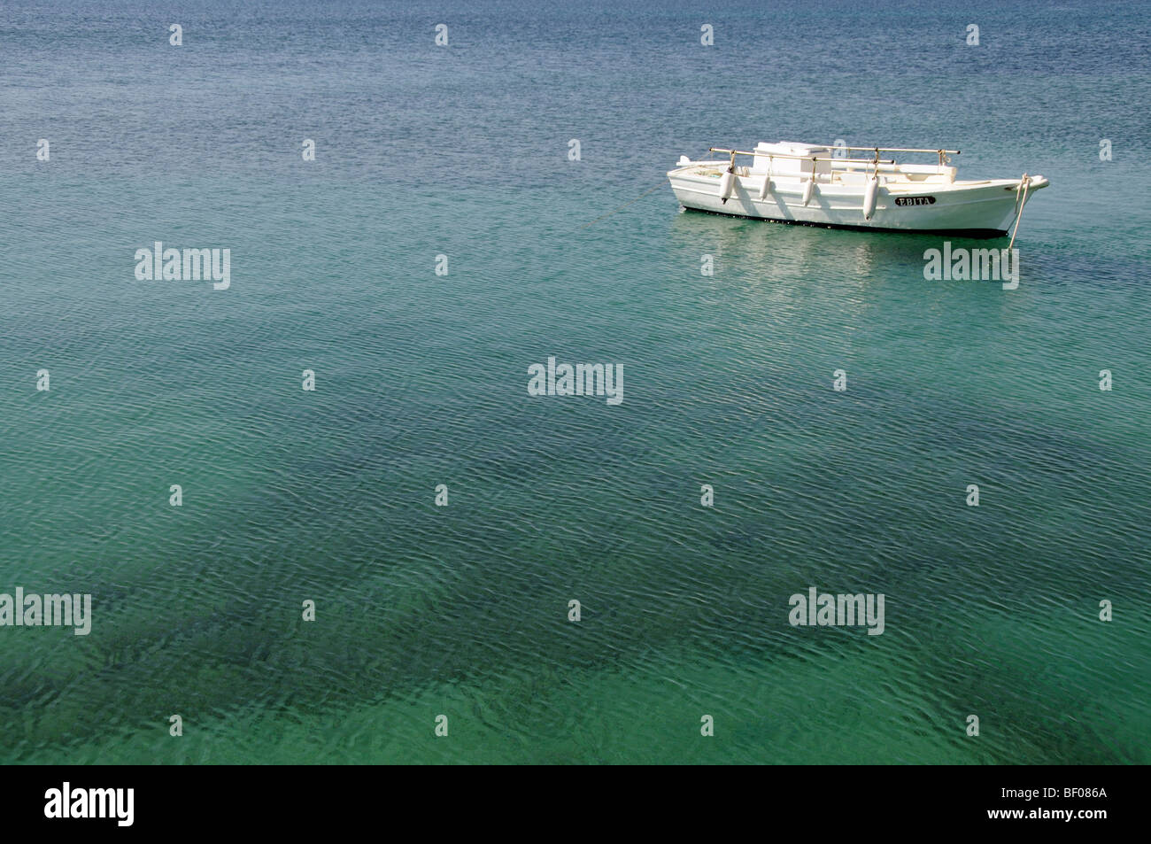 Small boat floating in the sea Stock Photo - Alamy