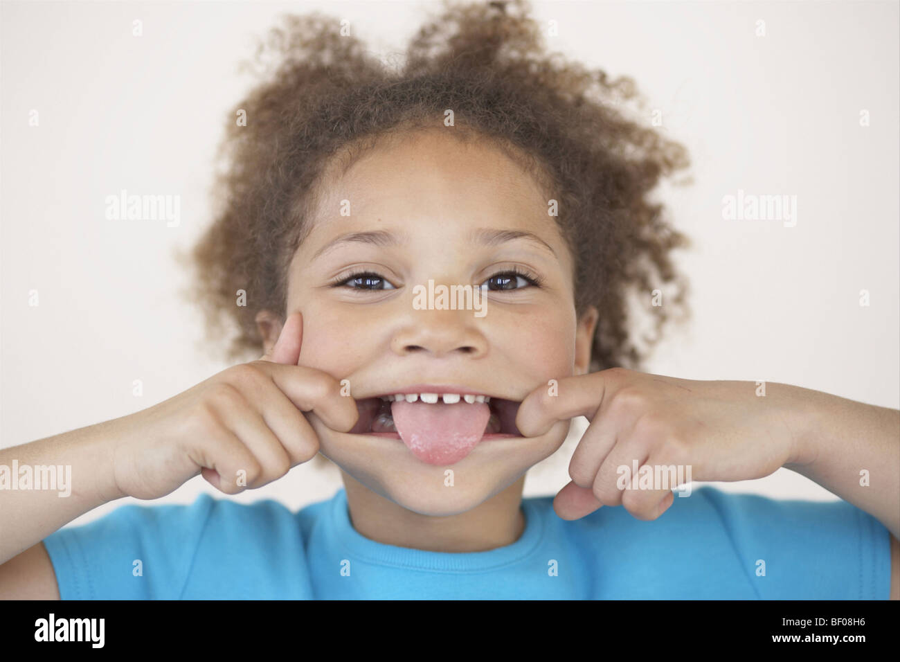 Child tongue out fingers hi-res stock photography and images - Alamy