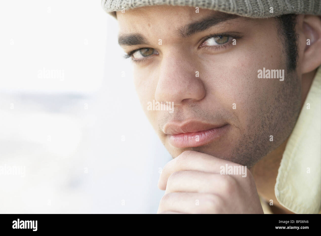 Portrait of a young man thinking Stock Photo - Alamy
