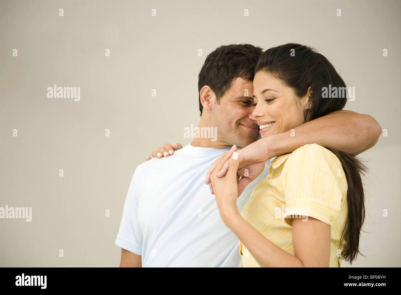 Mature man with his arm around a young woman Stock Photo - Alamy