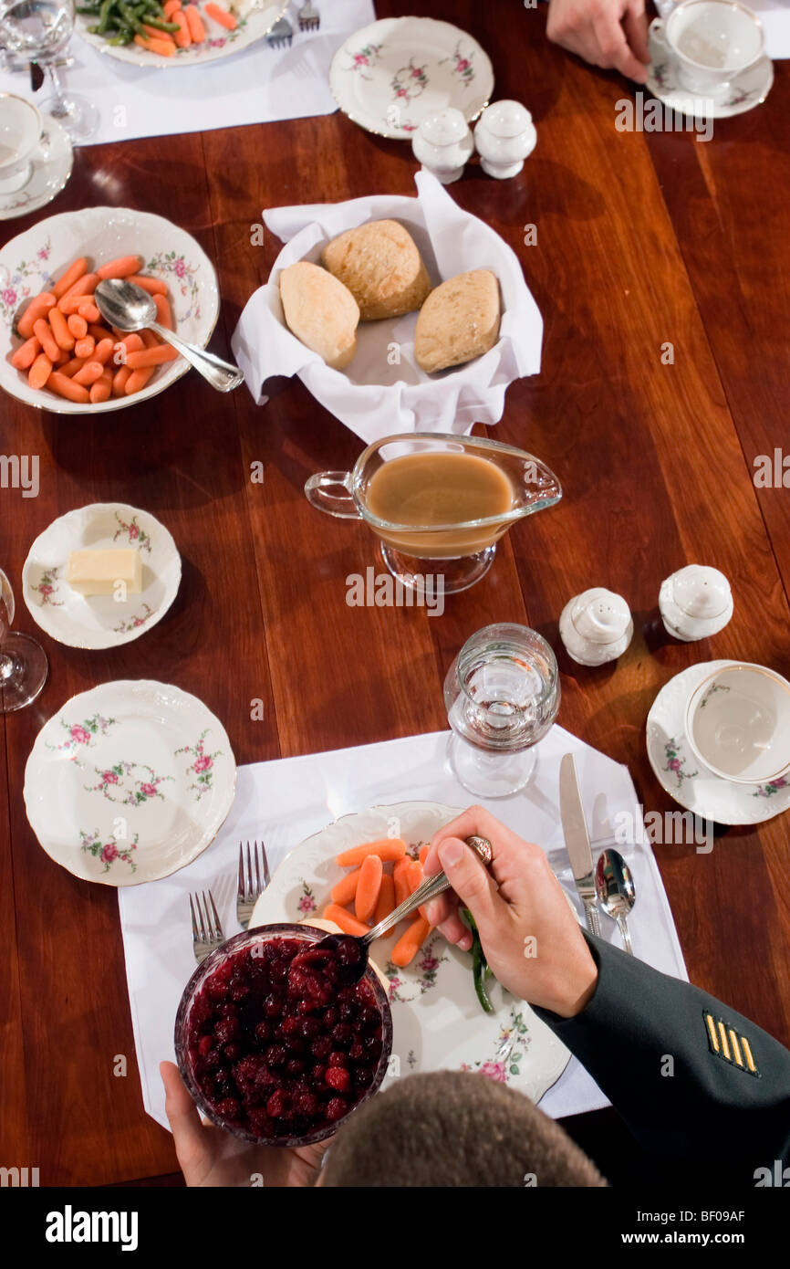High angle view of a young man serving food at a dining table Stock ...