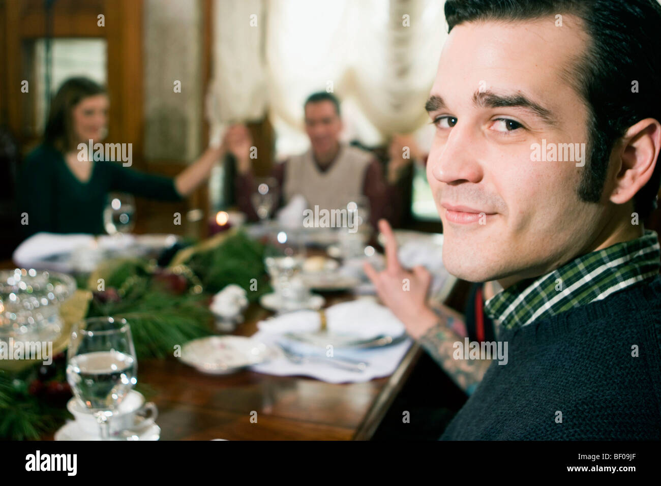 Portrait of a young man at a dining table Stock Photo - Alamy