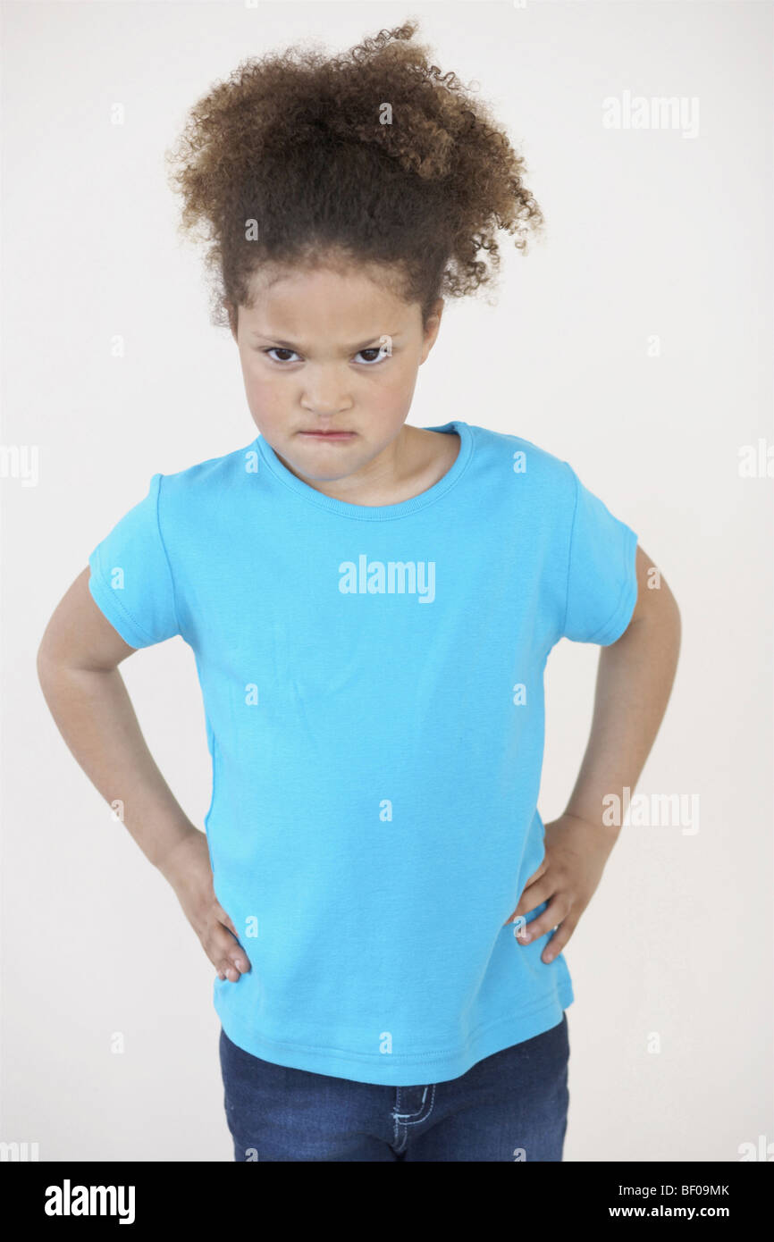 Close-up of a girl standing with her arms akimbo Stock Photo - Alamy