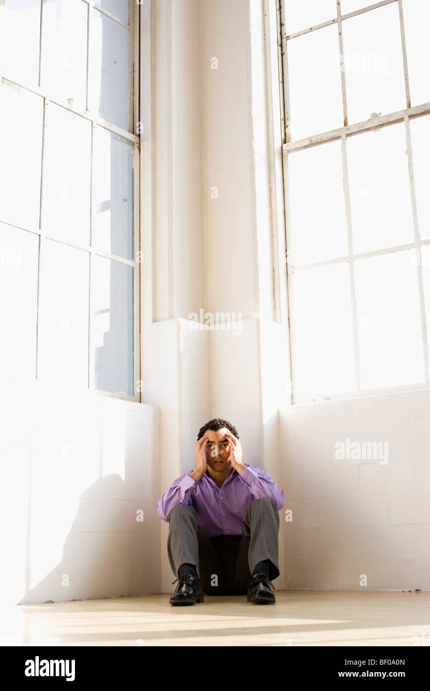 Sitting in corner head in hands hi-res stock photography and images - Alamy