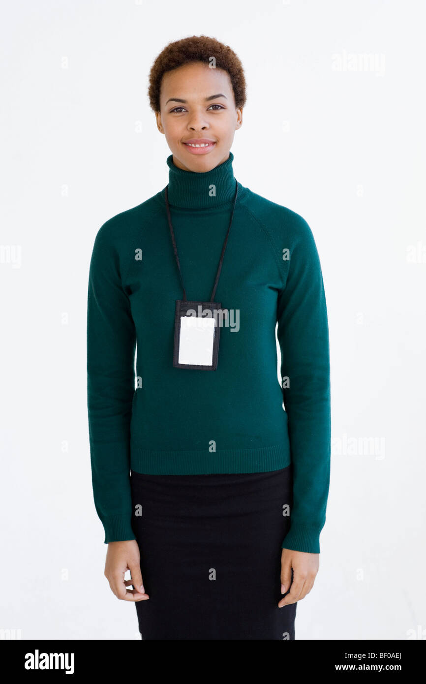 Businesswoman wearing an id card around her neck and smiling Stock ...